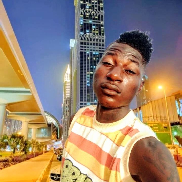 ALi Boubacar is standing on a building in Dubai and...