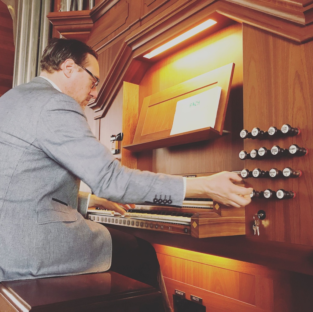 An player of a big pipe organ in search of harmony