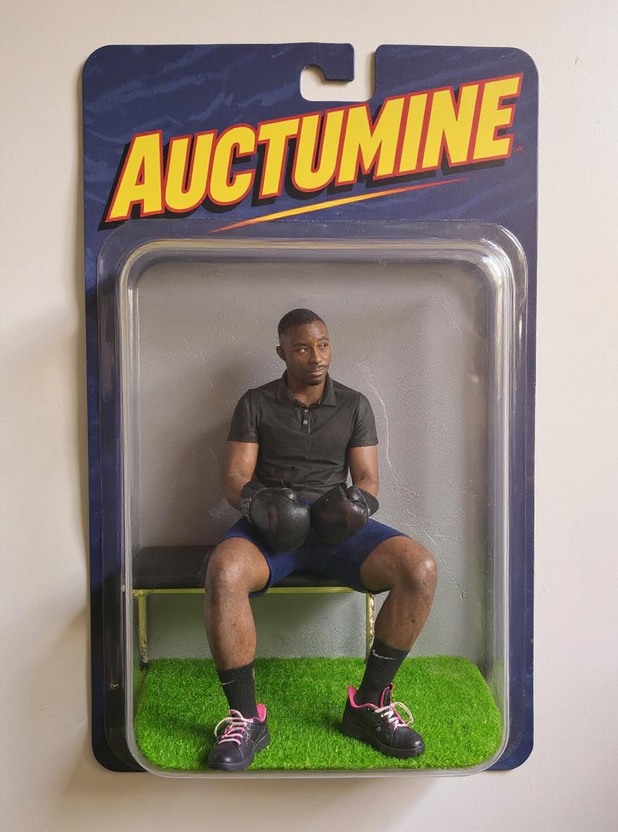 Make it an action figure in a box like it’s a product
